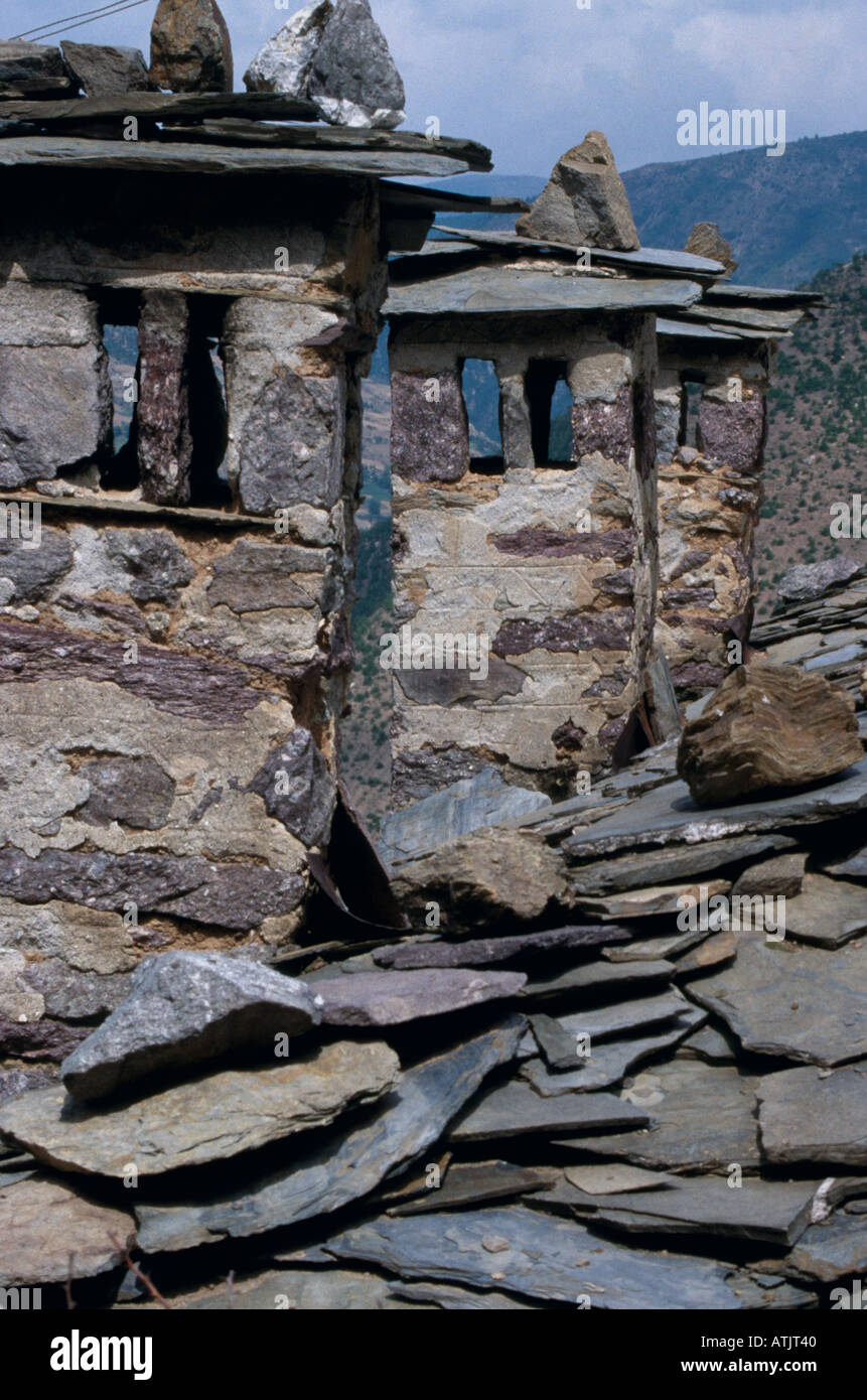 Traditional house roof with slate tiles and stone chimney stacks, Kukes ...