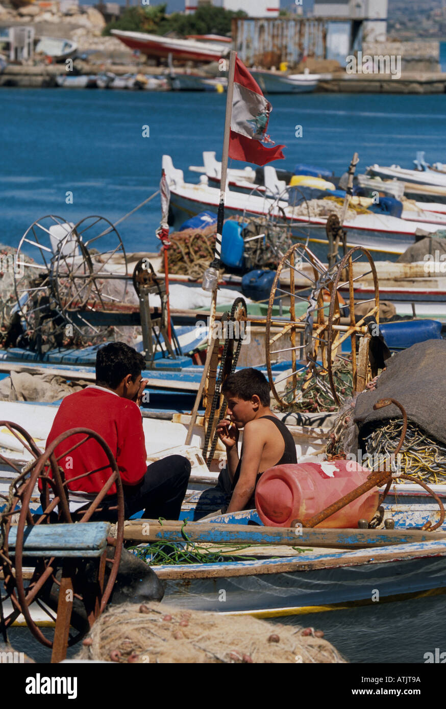Young boy smoking at fishing port of Saida. Lebanon Stock Photo - Alamy