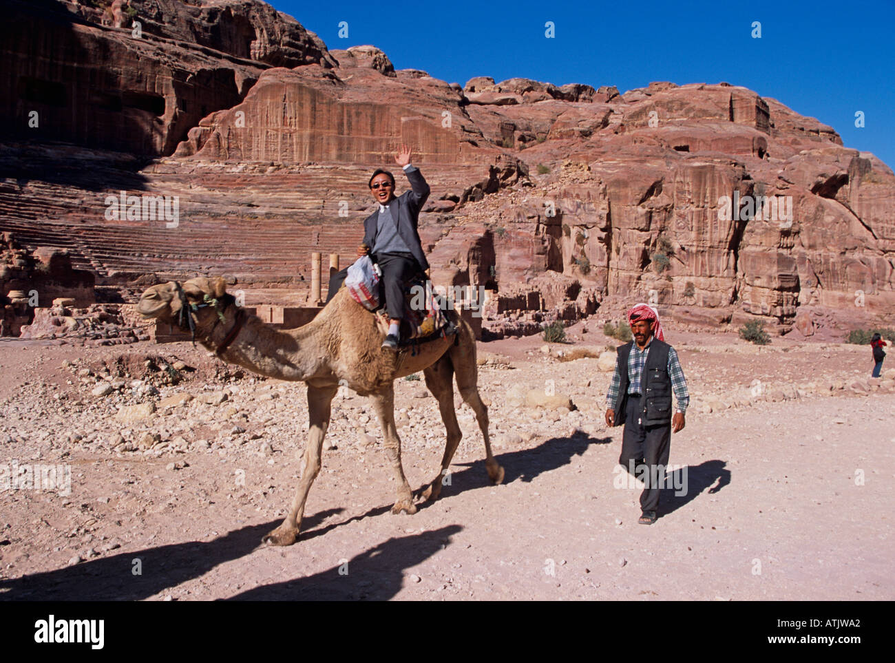 Tourist enjoying camel ride, Petra, Jordan Stock Photo - Alamy