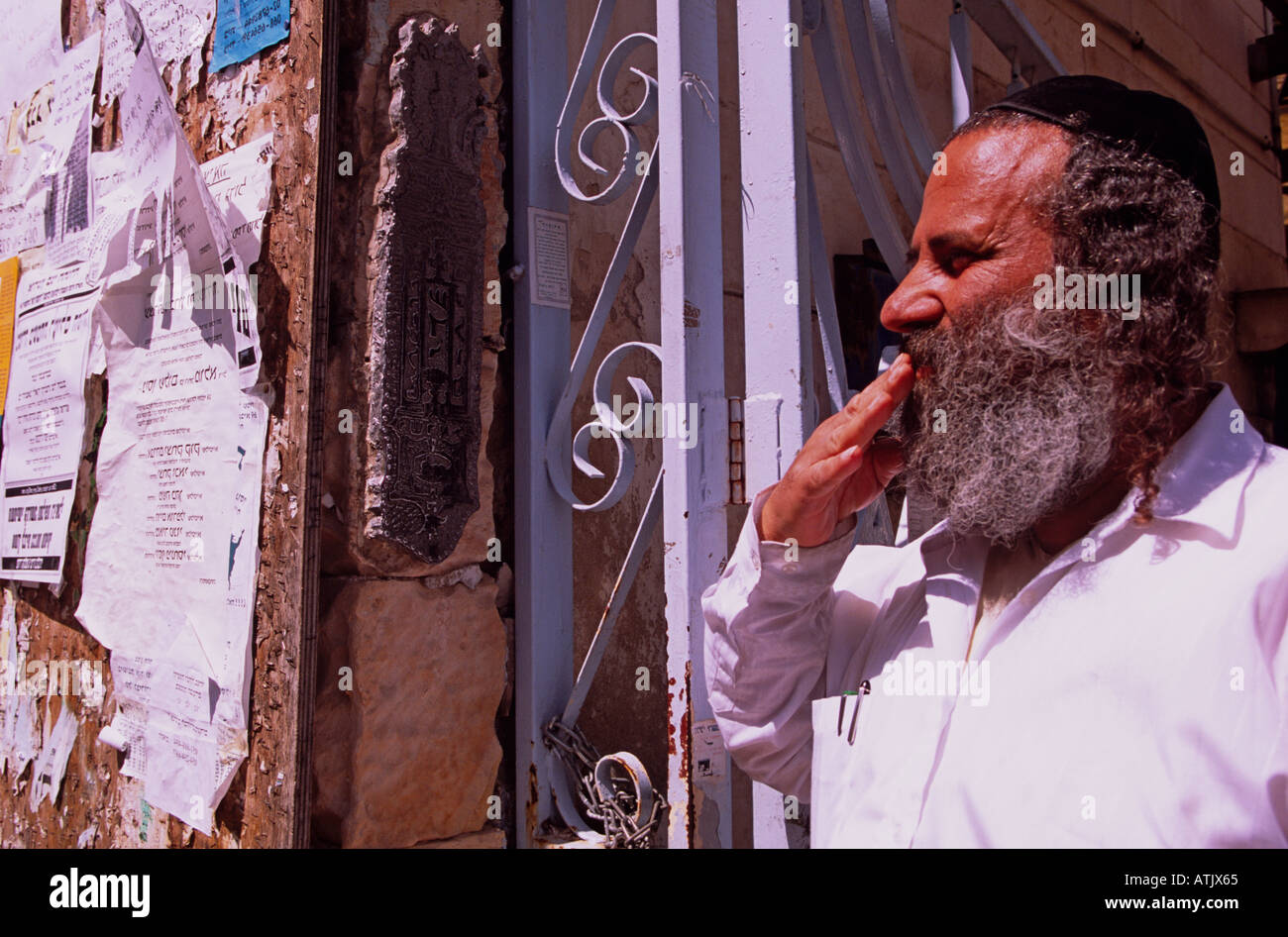 A rabbi smoking at a doorway in Mea Shearim Jerusalem Stock Photo - Alamy