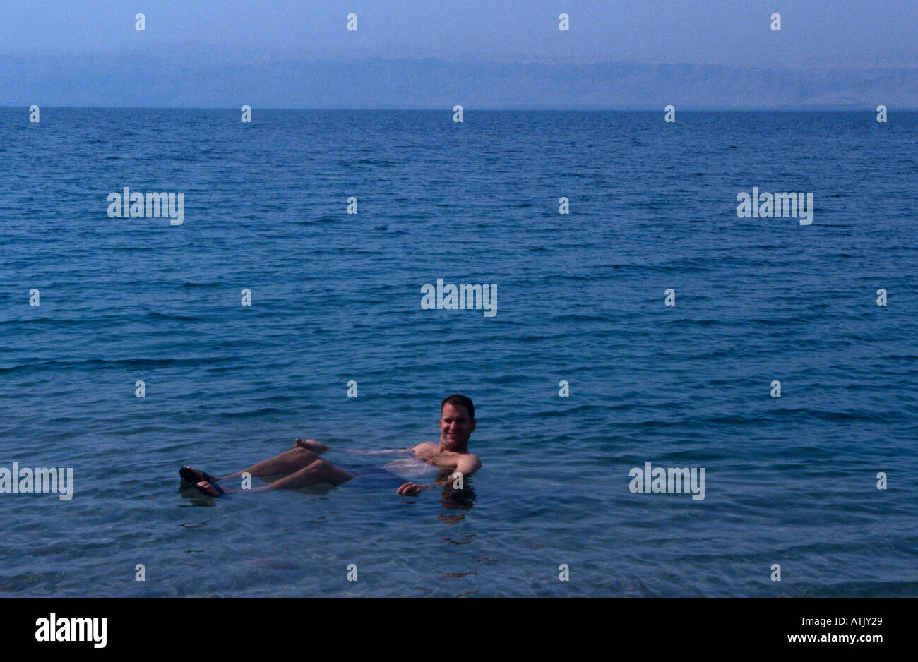 A man floating on the Dead Sea in Jordan Stock Photo - Alamy