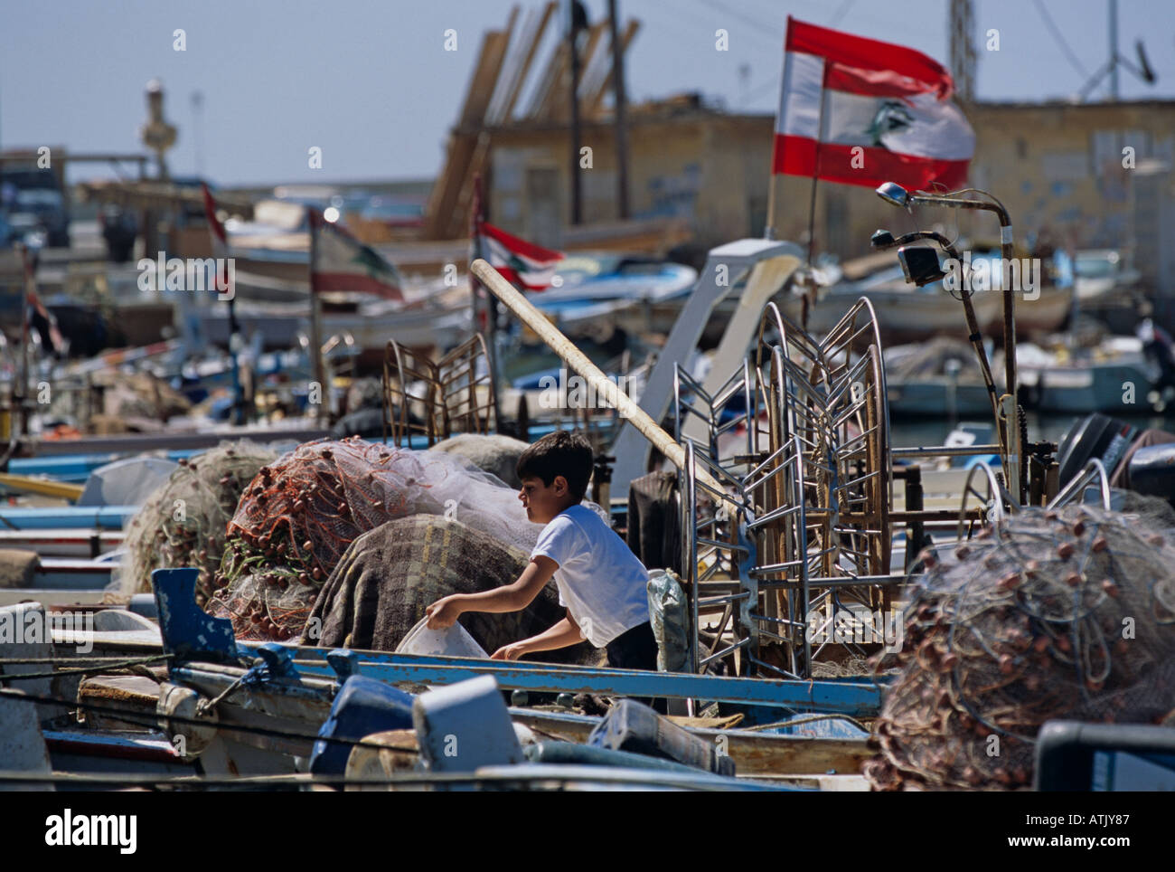 Boy working on fishing boats in the coastal city of Saida, Lebanon ...