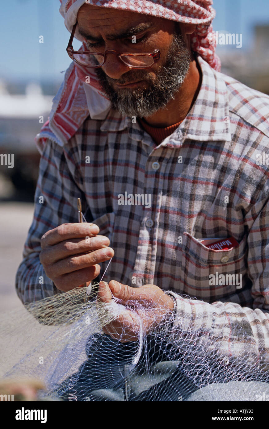 Fisherman fixing net, Saida, Lebanon Stock Photo - Alamy