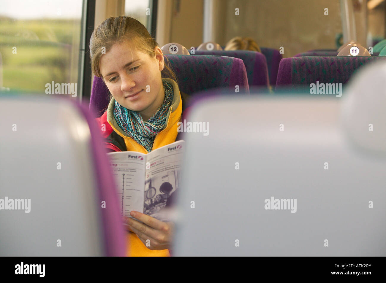 Woman reading rail timetable on train Stock Photo - Alamy
