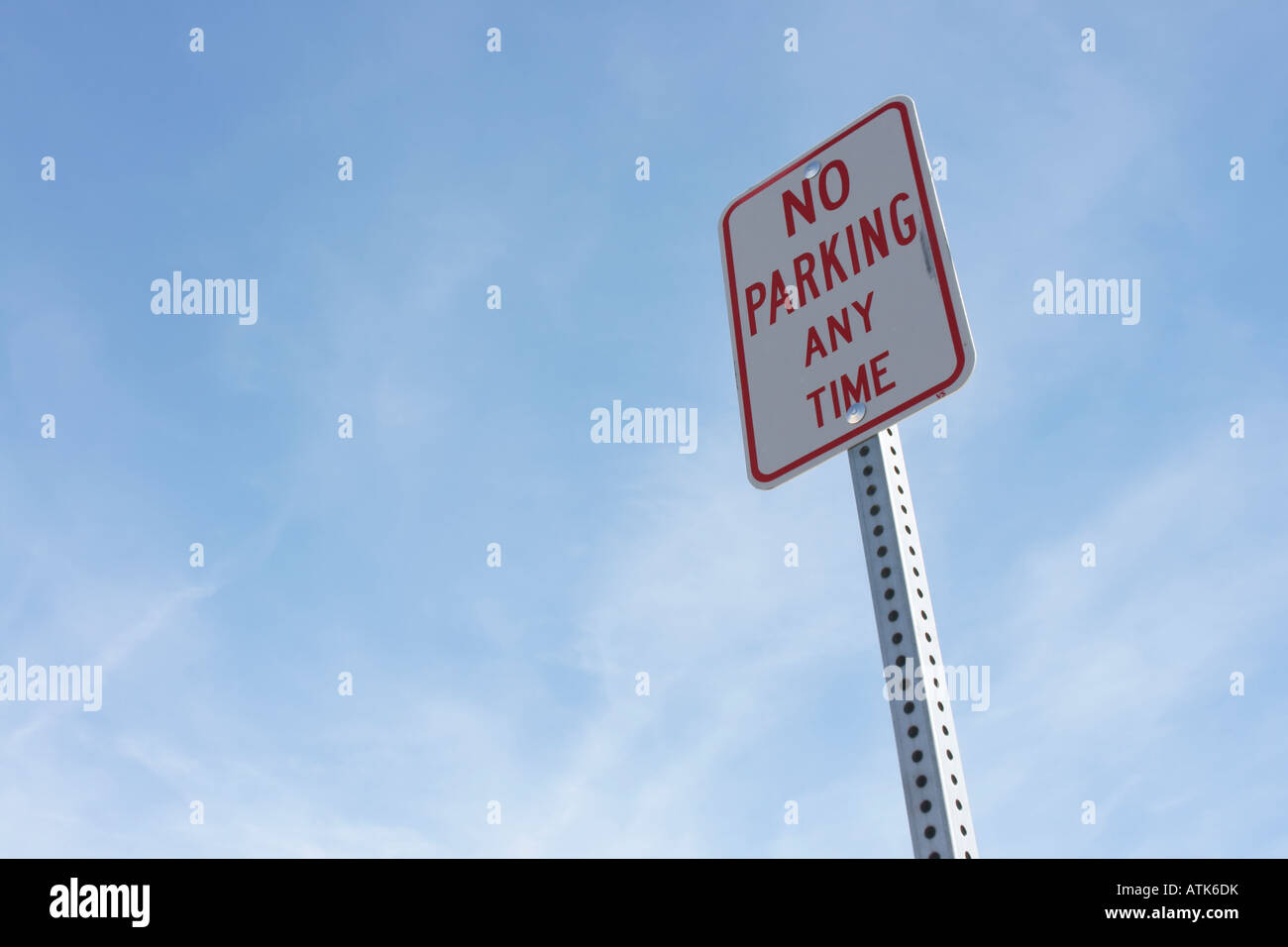 A "No Parking" sign imposed against a blue sky background Stock Photo ...