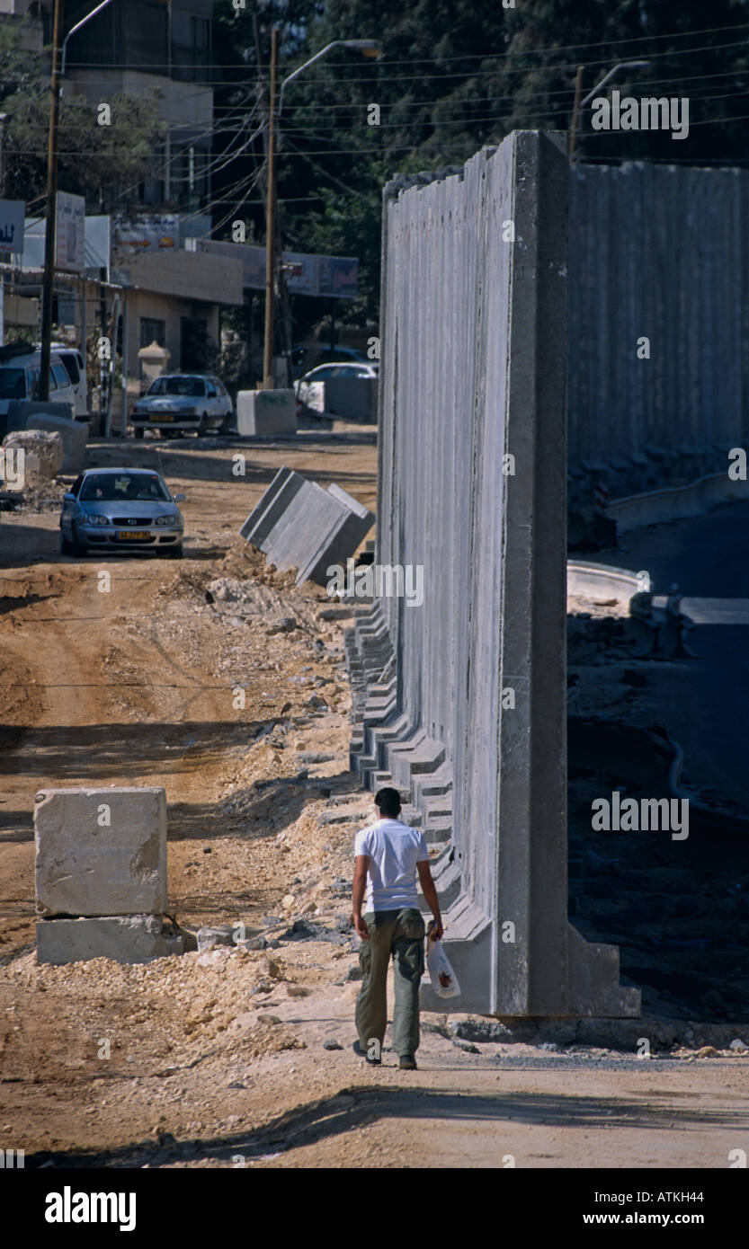 A man walking next to the Wall in Al Ram Jerusalem Stock Photo - Alamy