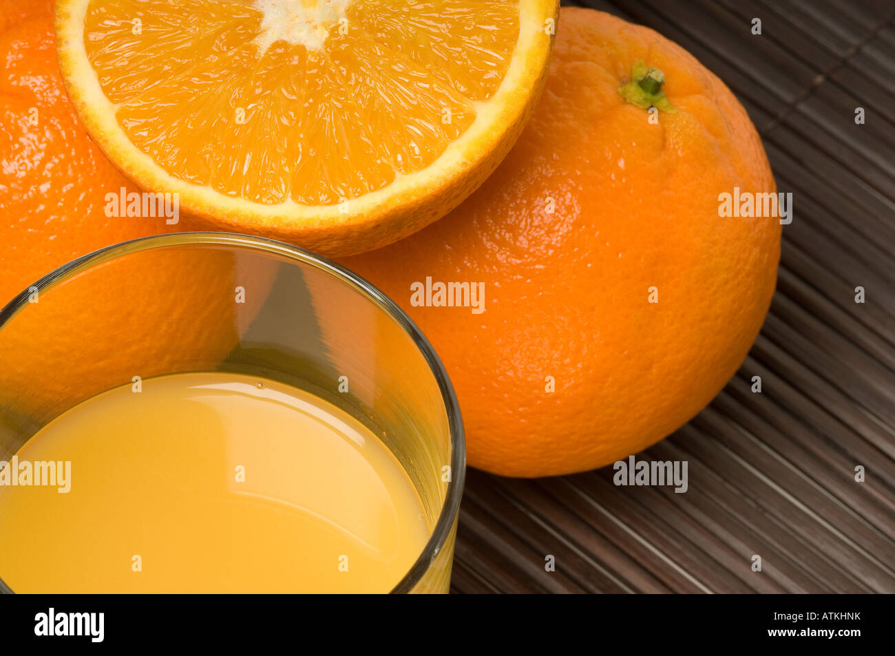 Whole and half oranges and glass of orange juice fruit close up Stock ...