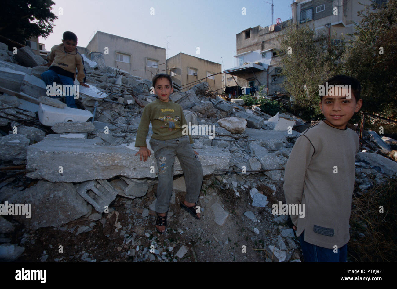 Children playing near the destroyed houses in Tulkarm Refugee Camp ...