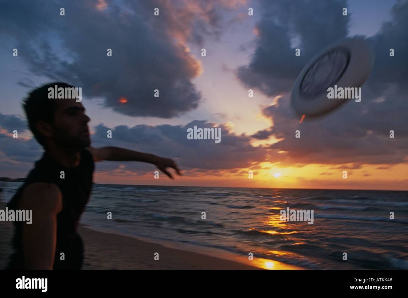 A man throwing frisbee on Herziliya beach Israel Stock Photo - Alamy