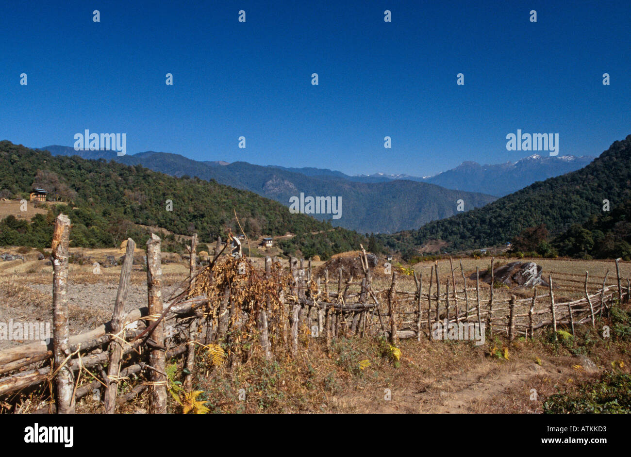 Scenic valley view with handmade agricultural fence and distant ...
