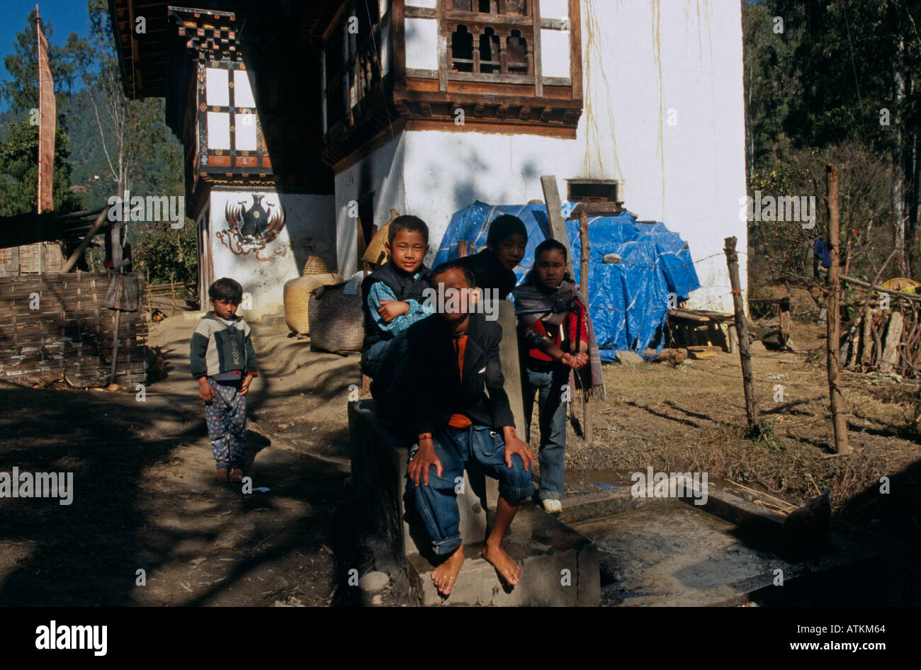 Curious children playing in village, Bhutan Stock Photo - Alamy