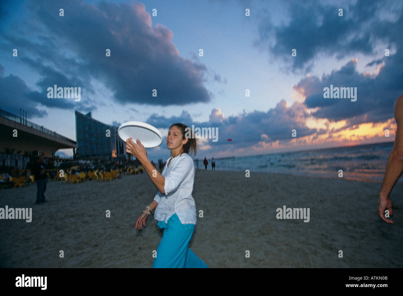 Woman playing frisbee, Herziliya beach, Beirut, Tel Aviv, Israel Stock ...