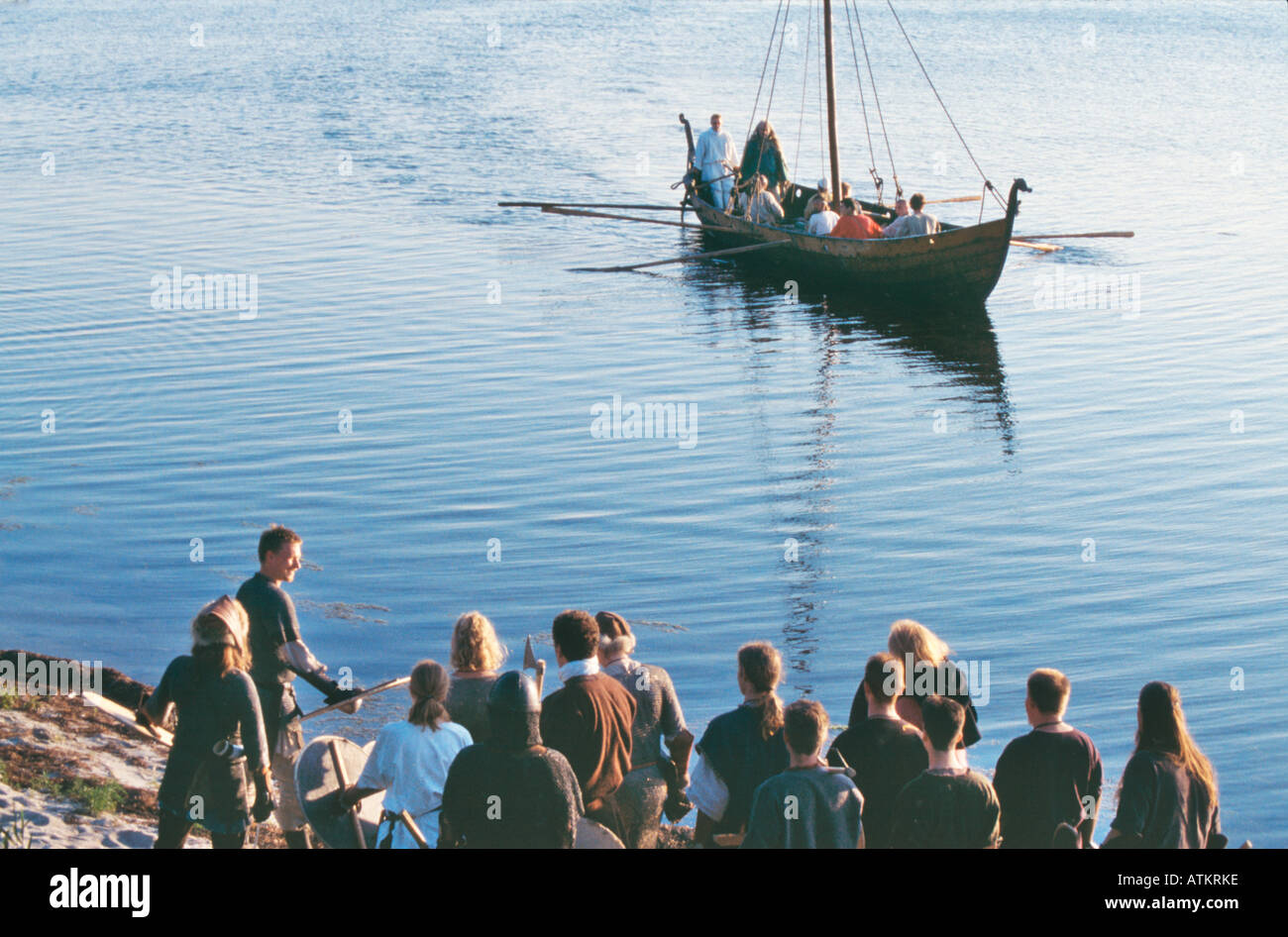 Vikings in longship approach shoreline Stock Photo - Alamy