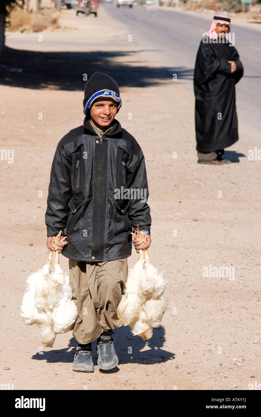 a young boy carrying chicken Stock Photo - Alamy