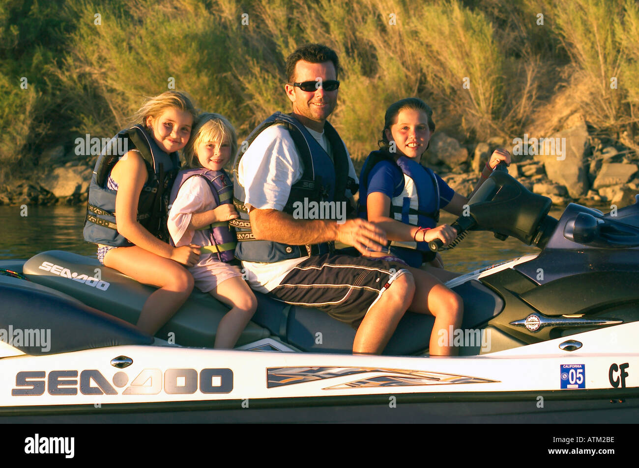 family on jet ski Stock Photo - Alamy