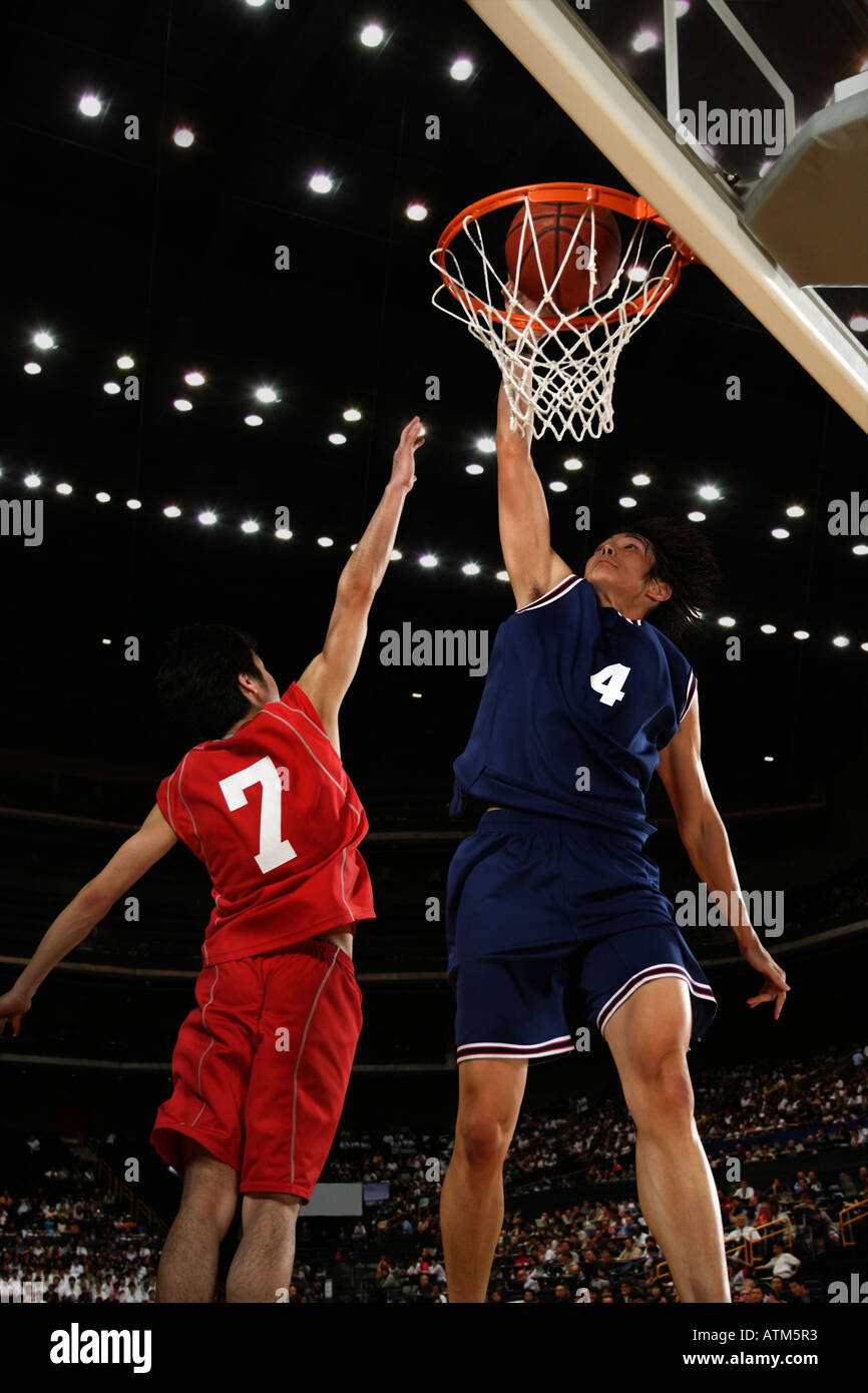 Young Asian basketball player making a dunk Stock Photo - Alamy