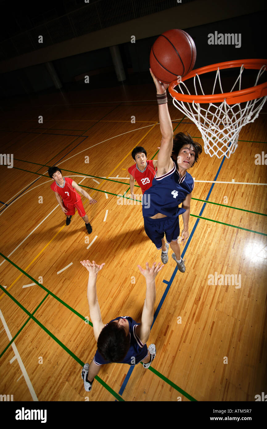 Young Asian basketball player making a dunk Stock Photo - Alamy