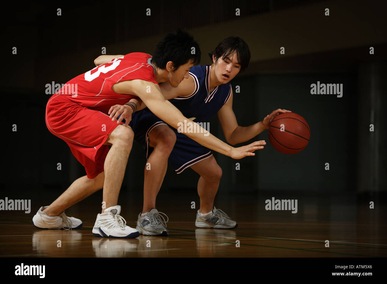 Two young Asian basketball players on court Stock Photo - Alamy