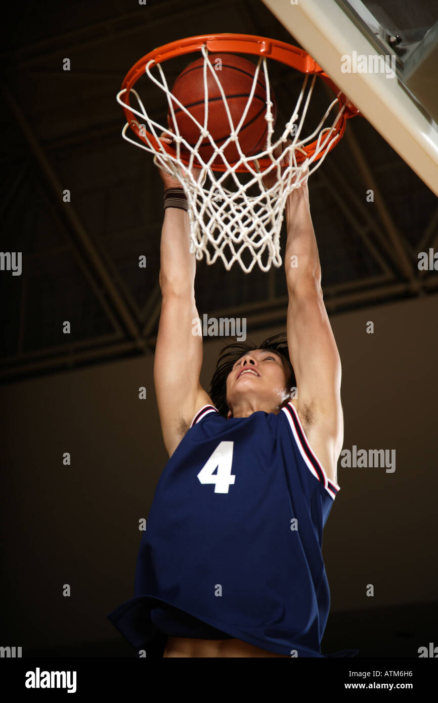 Young Asian basketball player making a dunk Stock Photo - Alamy