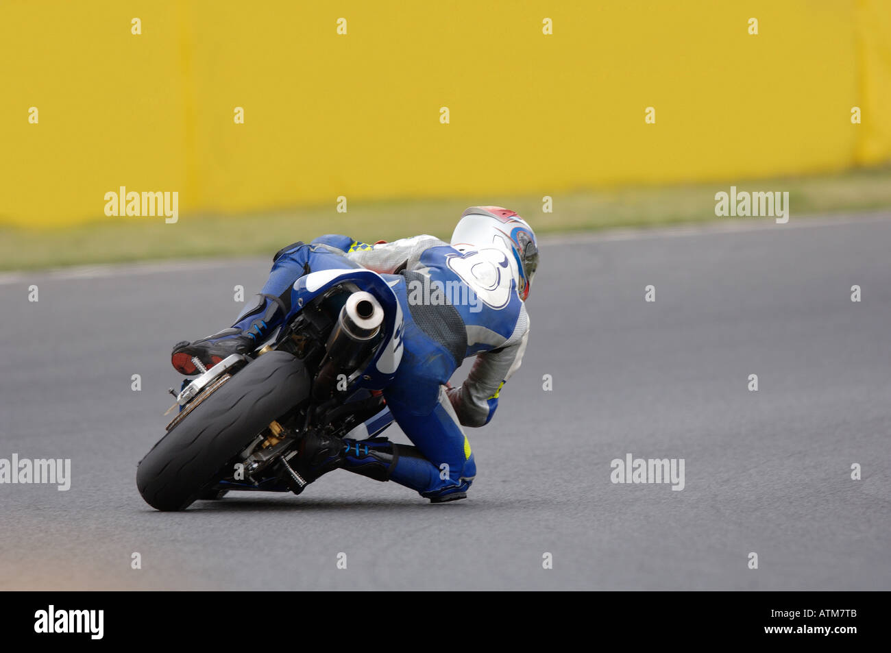 Racing motor bike cornering at extreme angle Stock Photo - Alamy