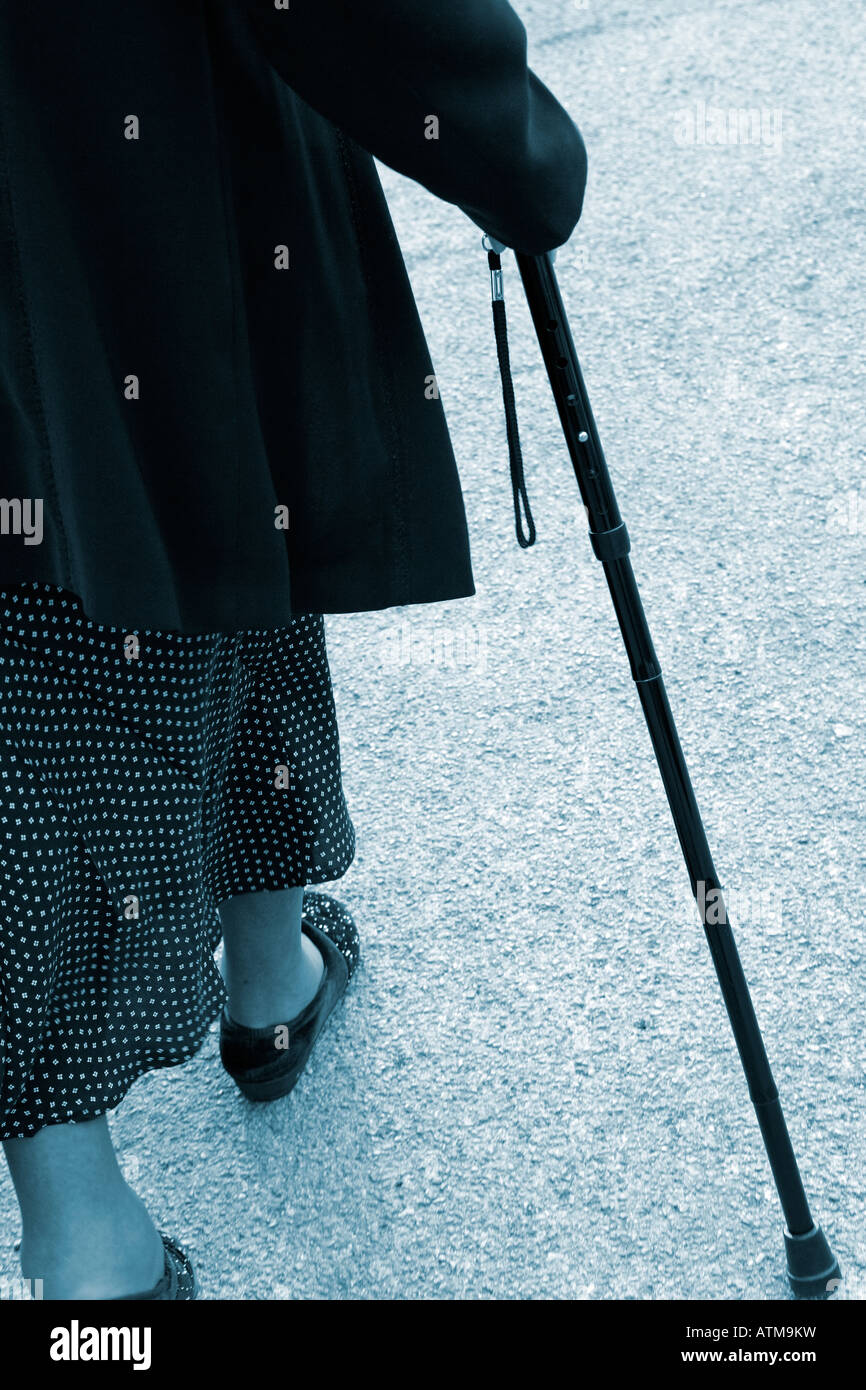 Elderly woman with walking stick Stock Photo - Alamy