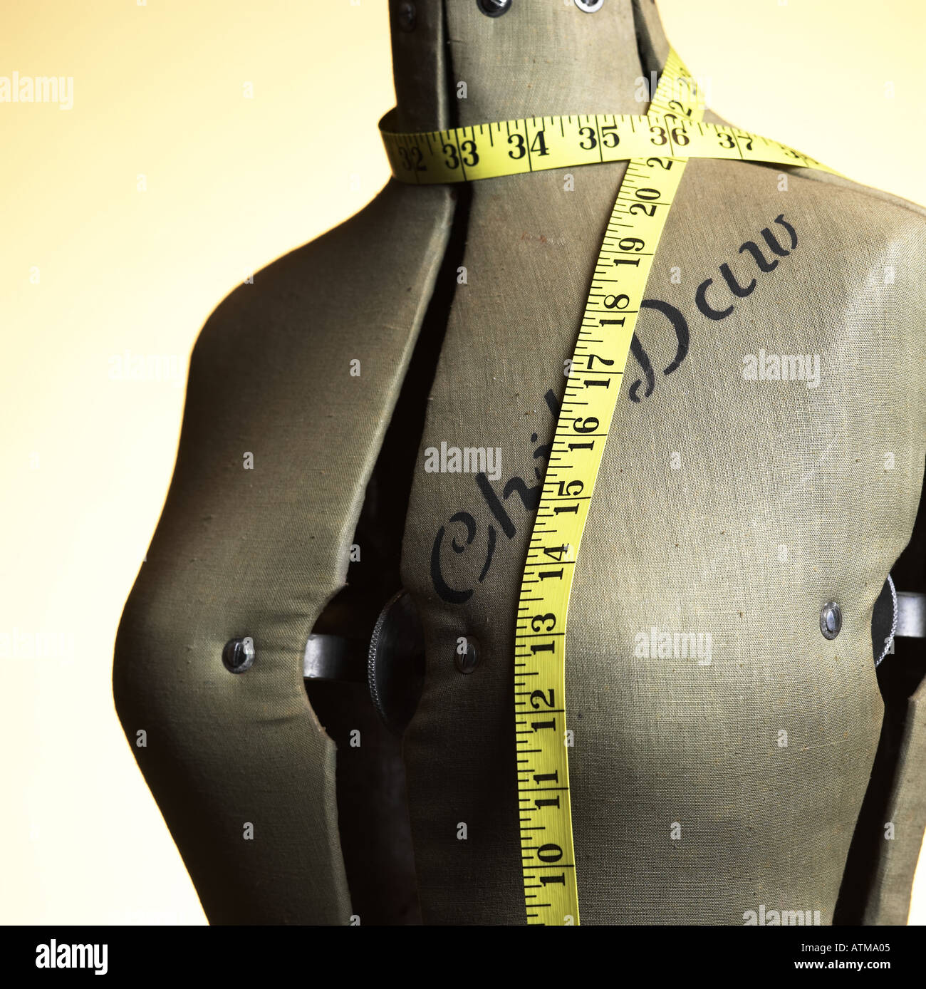 an orange dress makers tape measure with the inches scale showing ...