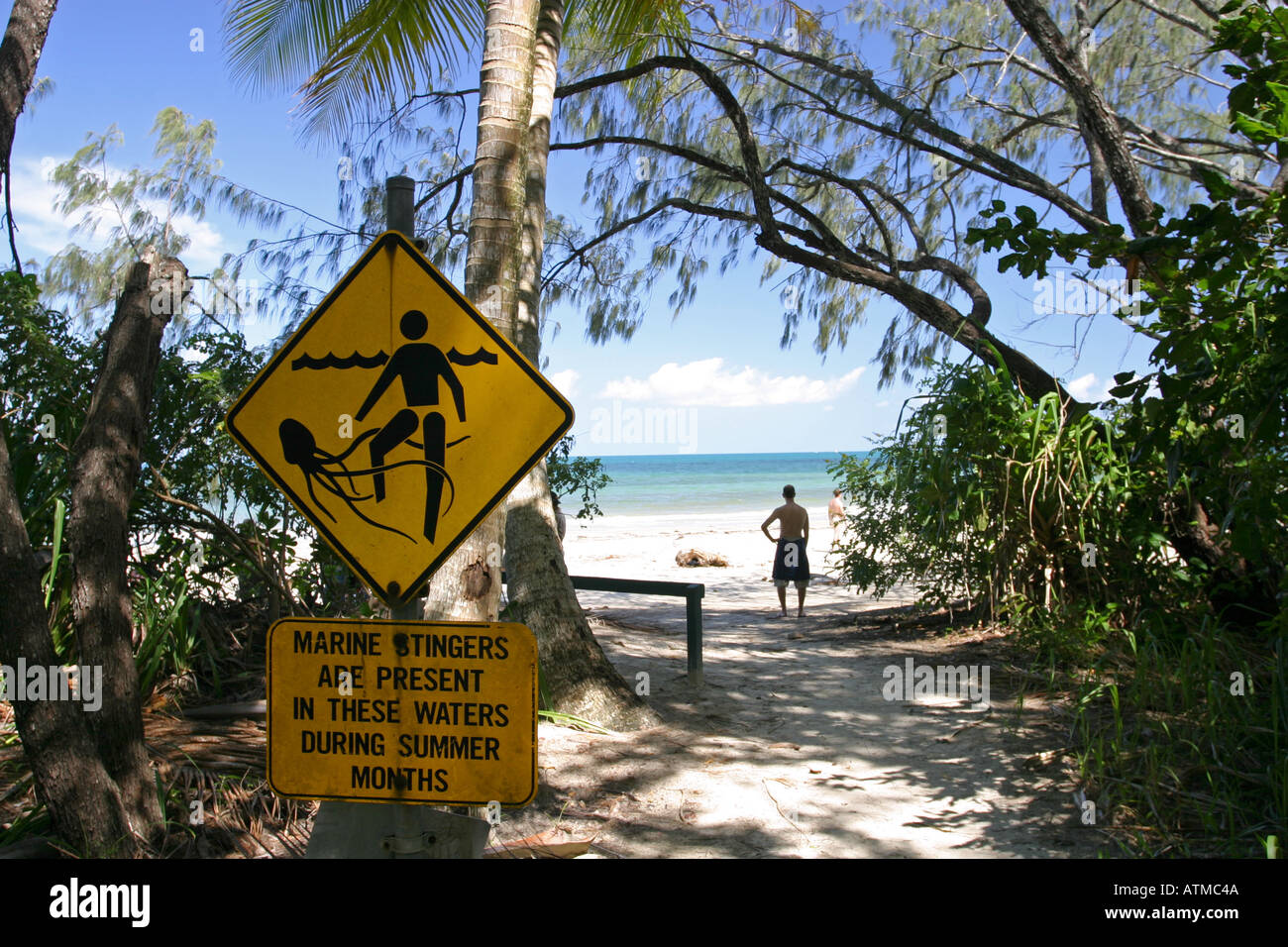 Yellow safety sign warns of dangerous stinger box jelly fish in summer ...