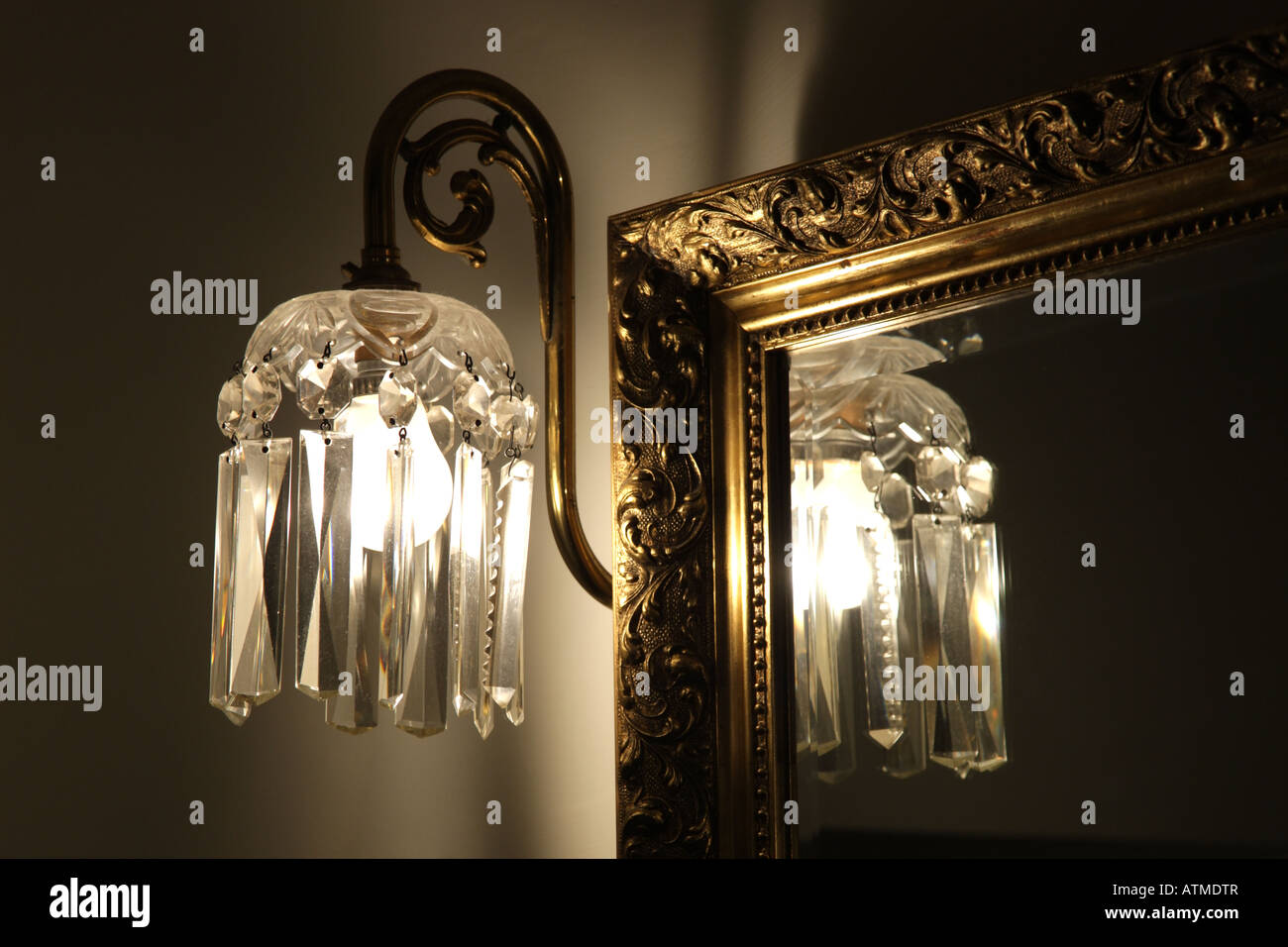 A crystal wall light reflected in a mirror Stock Photo - Alamy