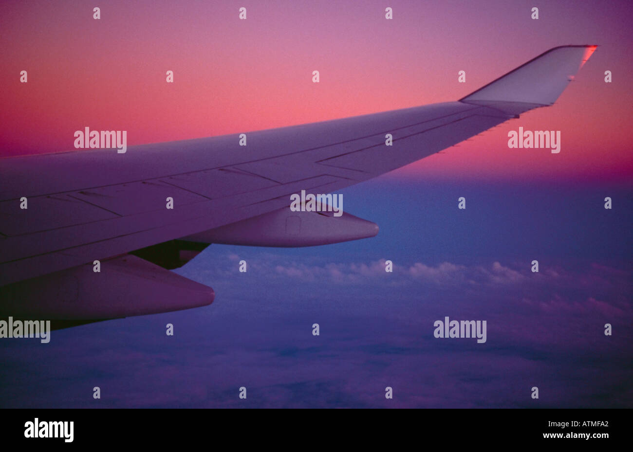 Aircraft wing over Pacific Ocean at sunrise Stock Photo - Alamy