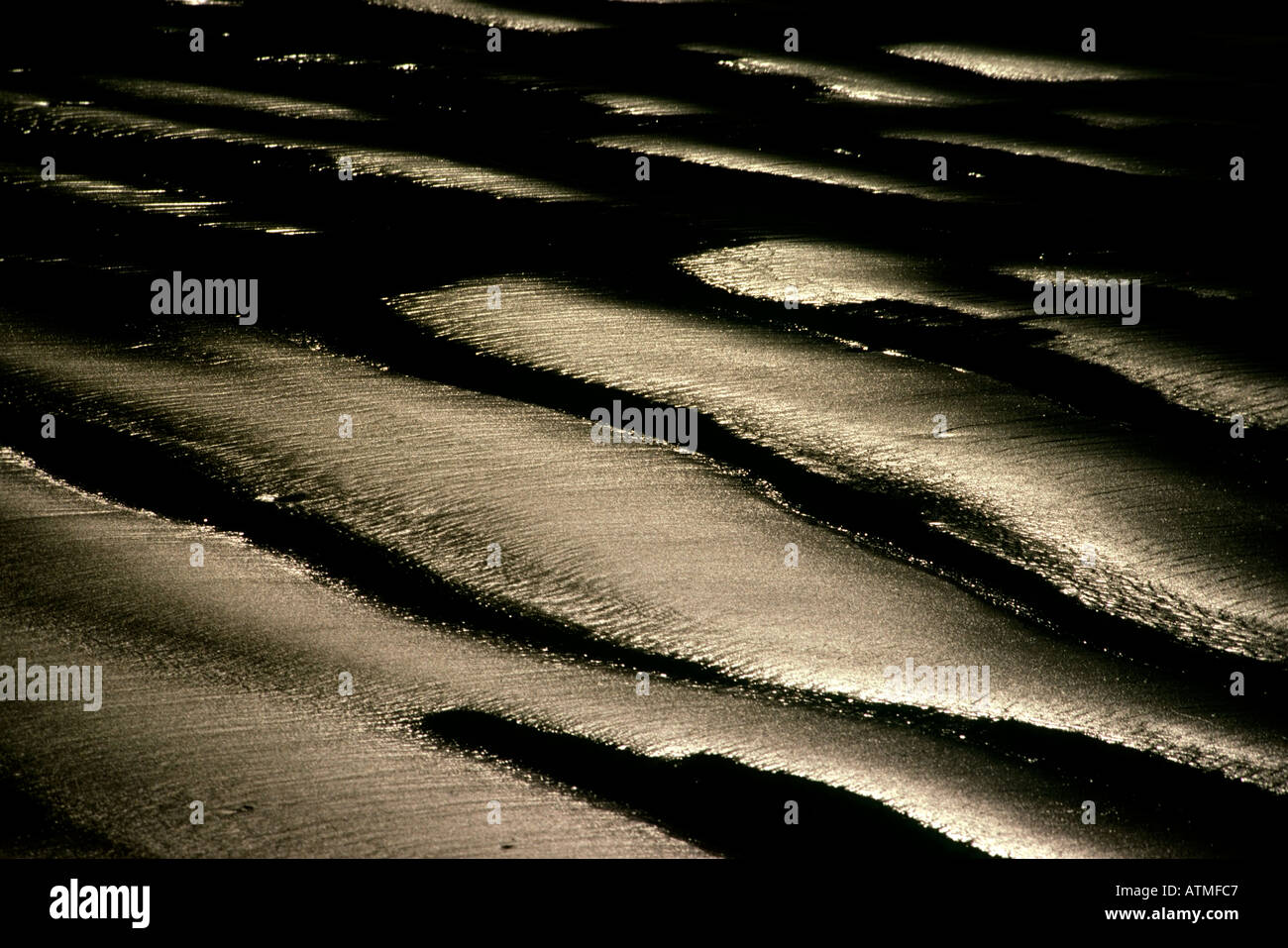 Sand, shadow and water patterns on the beach at Essaouira, Morocco ...