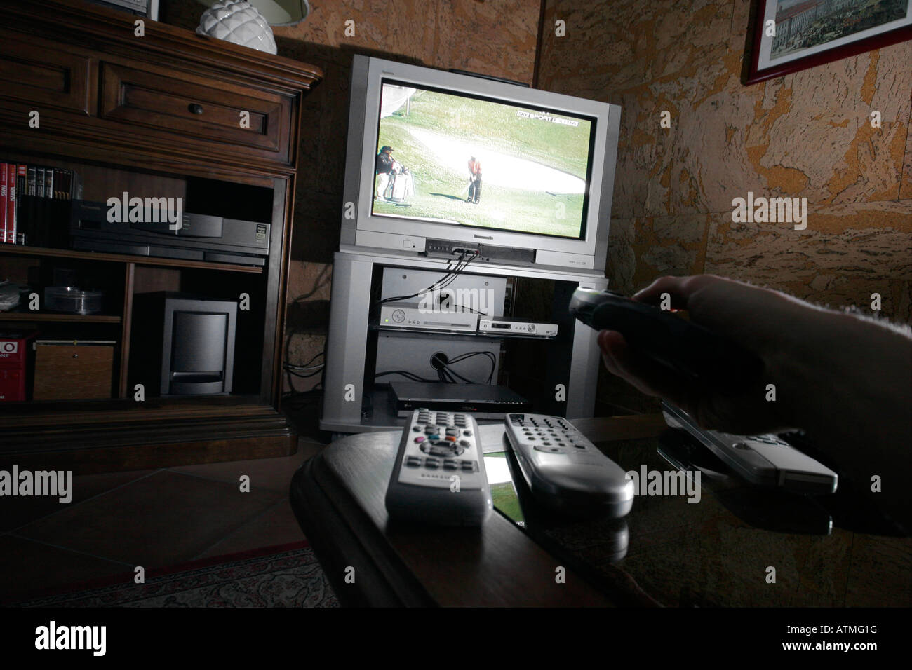 Man using remote control watching television at home Stock Photo - Alamy