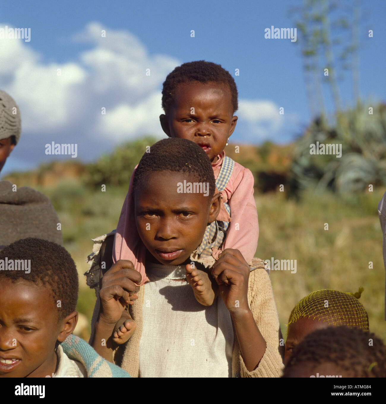 Boy carrying little child Stock Photo - Alamy