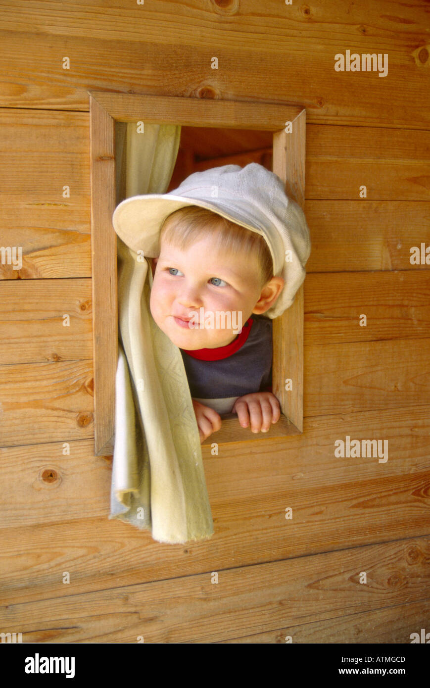 Boy looking out of window Stock Photo - Alamy