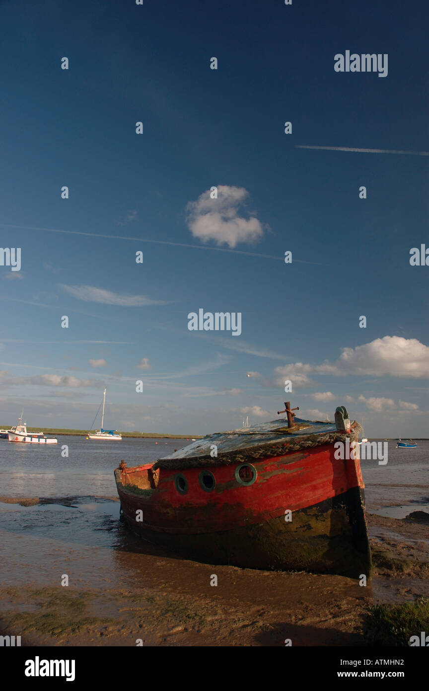 Vintage red sea boat on beach with clear blue sky Orford Ness UK Europe ...
