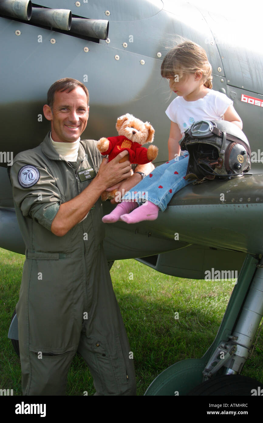 Spitfire pilot Dave Ratcliffe with little girl sitting on the wing of ...