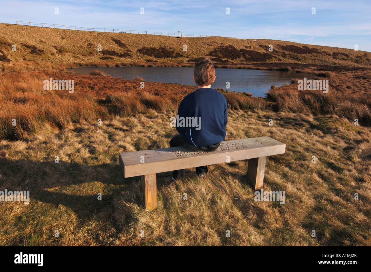 A Boy Sitting Alone On A Wooden Seat,Located On The Staffordshire ...