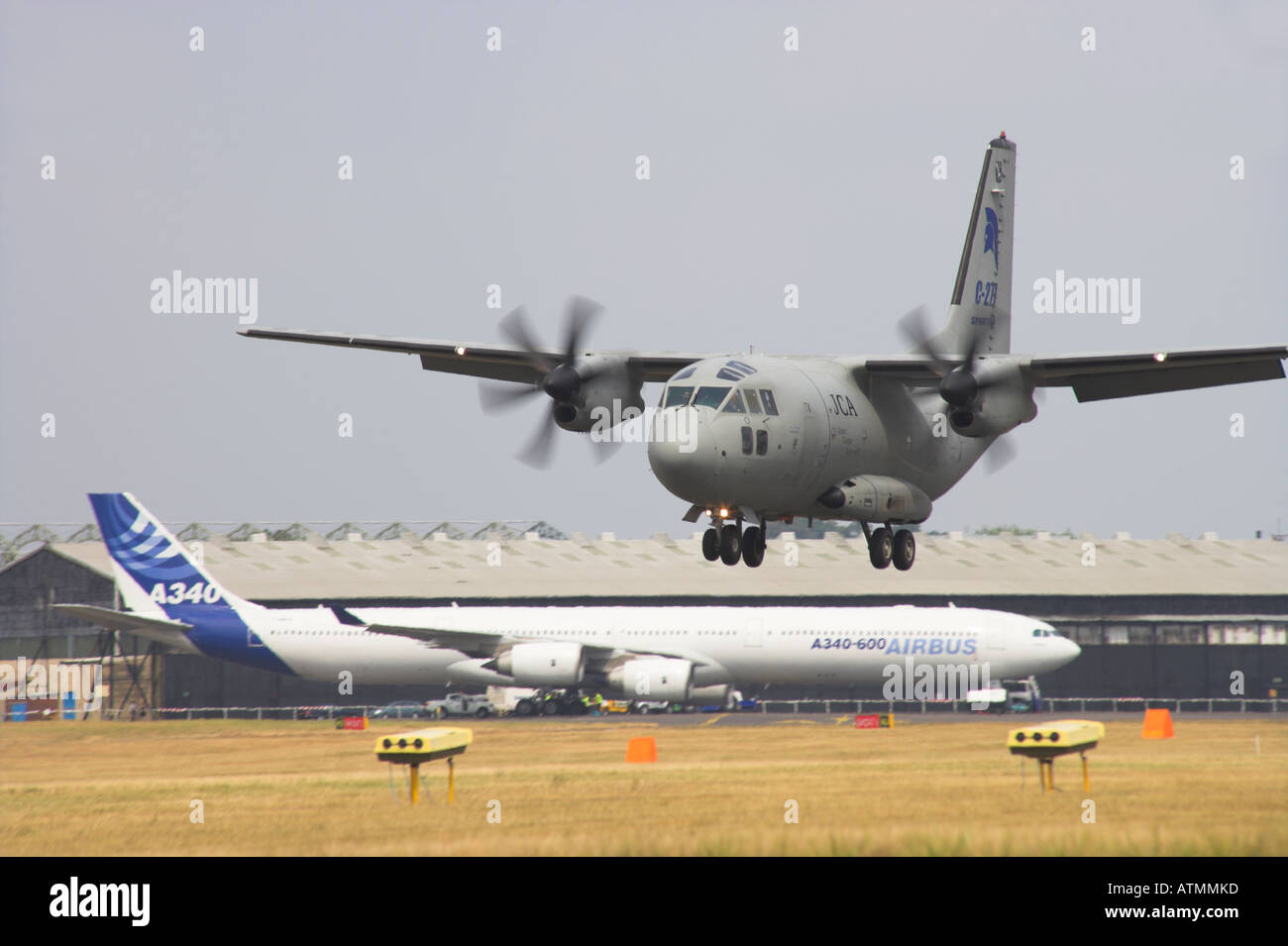 Spartan C 27 J coming in to land with Airbus A340 600 in background ...