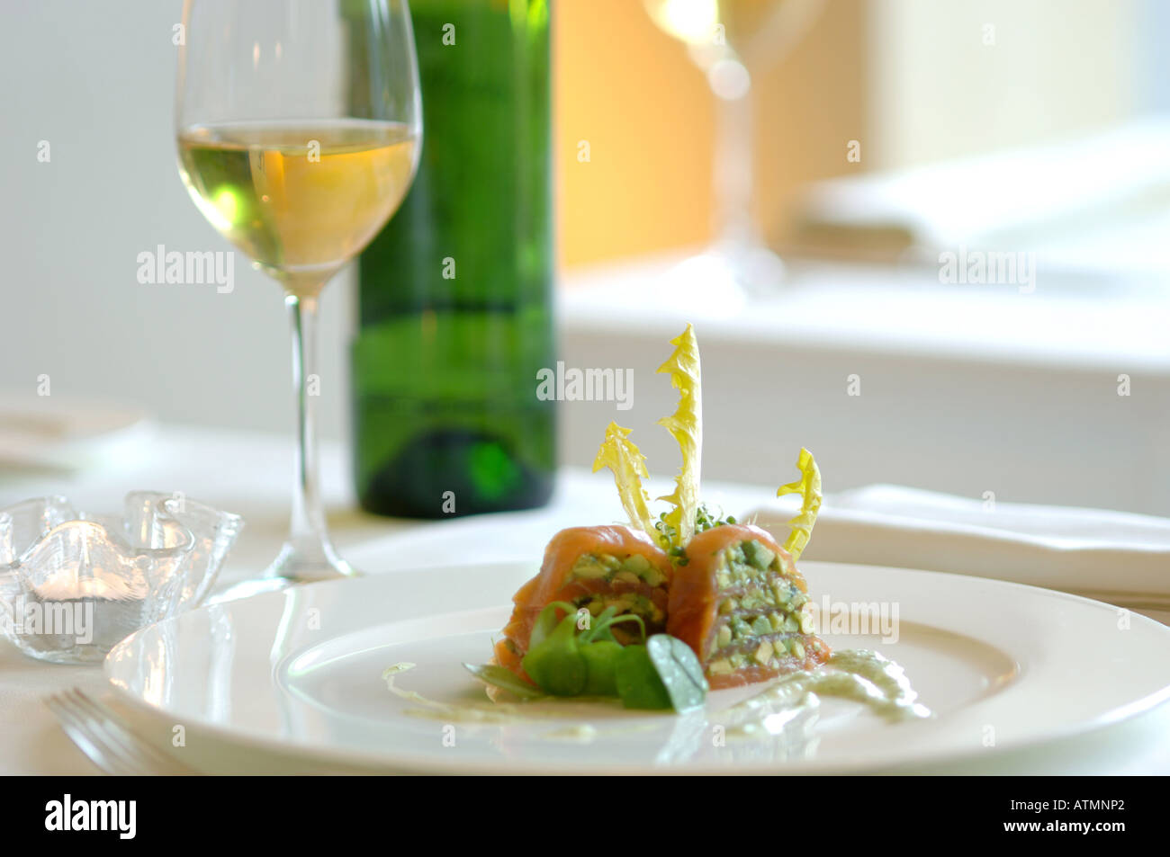 food and white wine on a nicely set table Stock Photo - Alamy