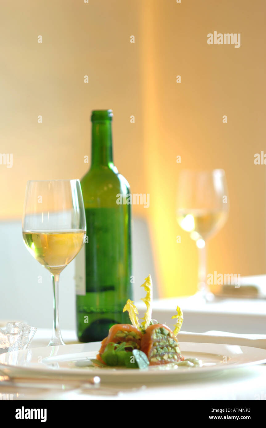 food and white wine on a nicely set table in a restaurant Stock Photo ...