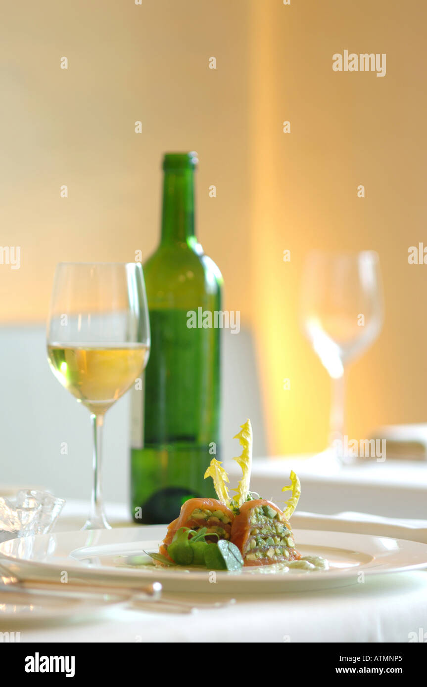 food and white wine on a nicely set table in a restaurant Stock Photo ...