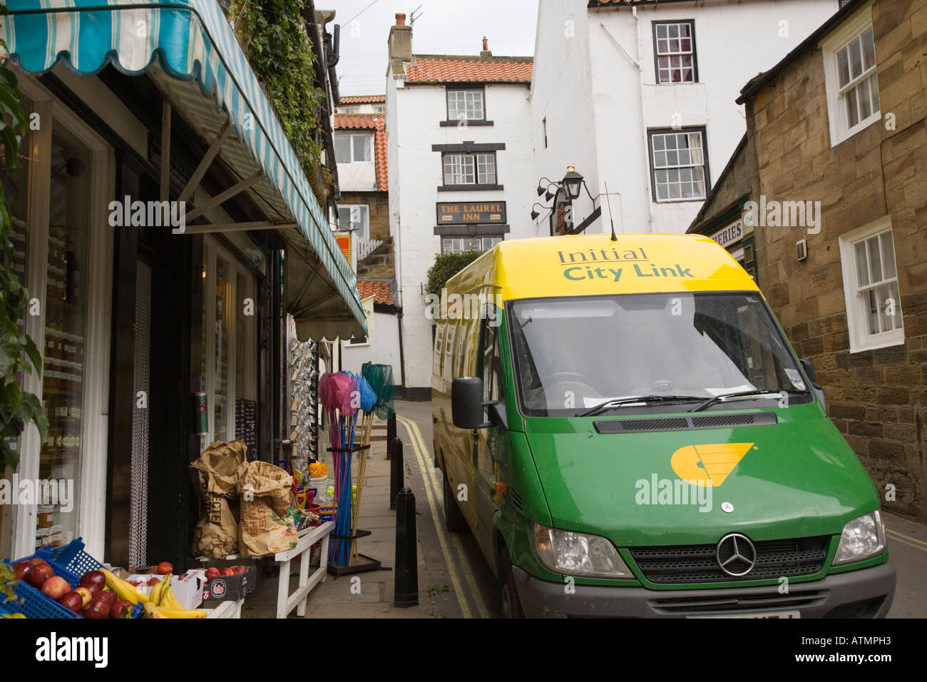 Initial City Link green and yellow courier van delivering to shop in ...