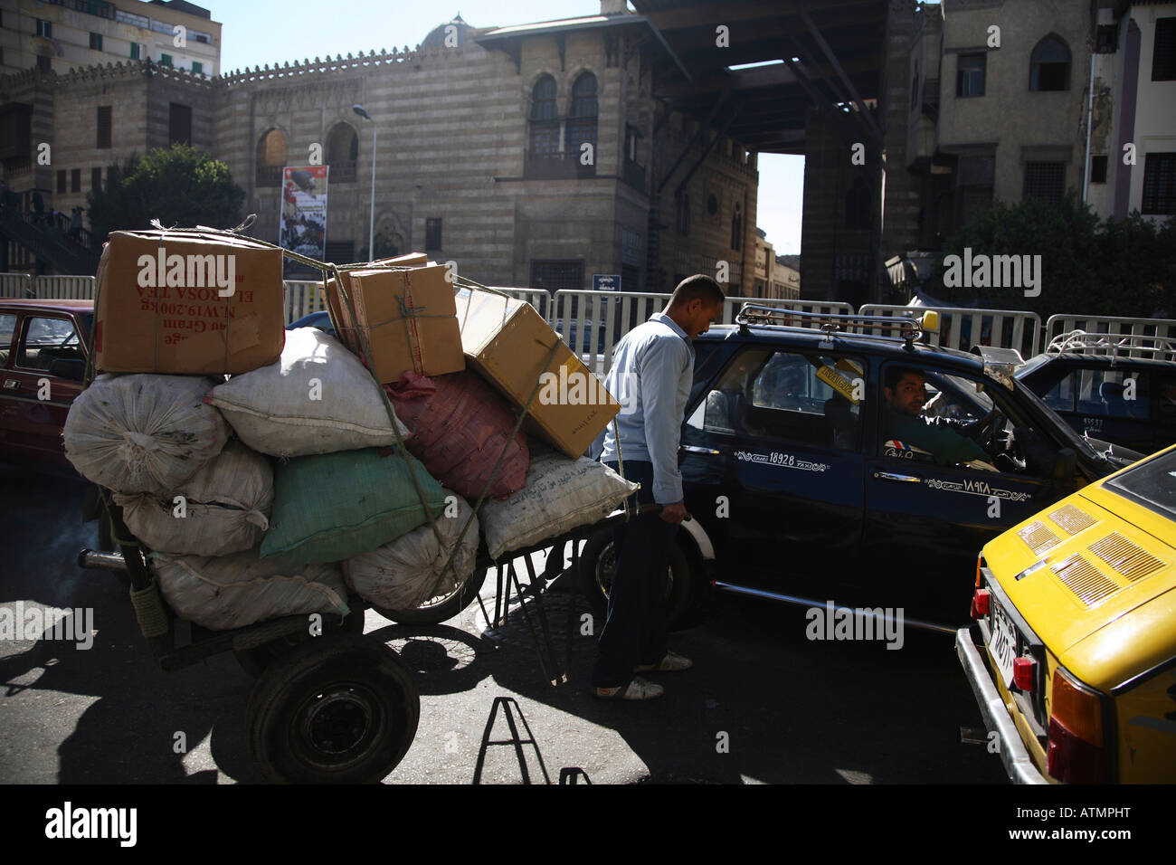 A man is moving heavy goods near Khan El-Khalil in Cairo Stock Photo ...