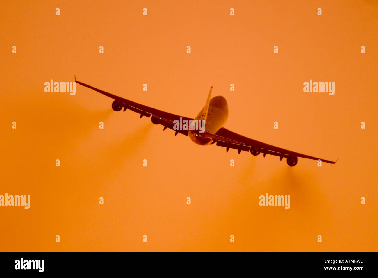 Commercial jet flying with smoke comeing from the engines Stock Photo ...