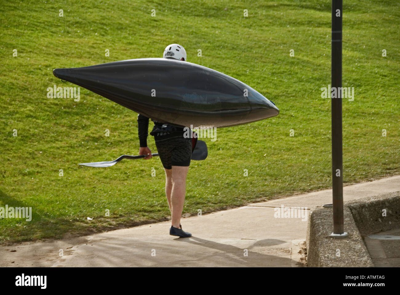 Man carrying Kayak on shoulder back to the start of the kayak slalom ...