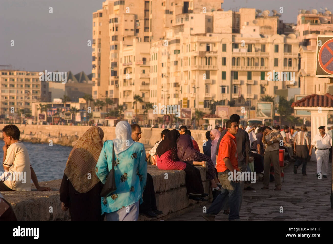 Egyptians walking along the corniche seaside walkway in Alexandria ...