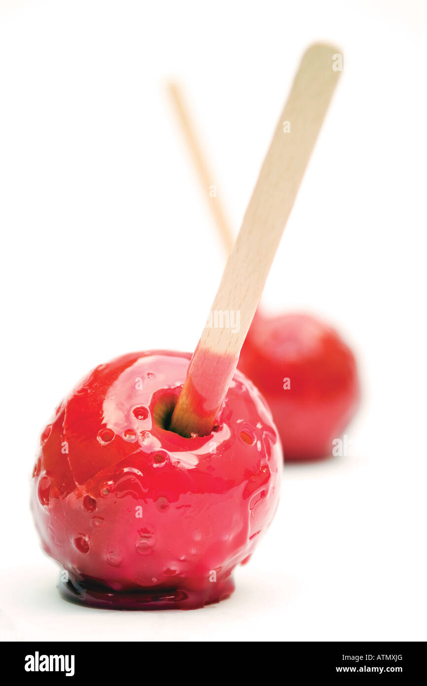 Two red glazed toffee apples (candy apples) on white background Stock ...
