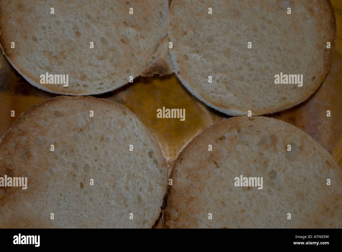 Two English muffins showing their inner upper surface after being split ...