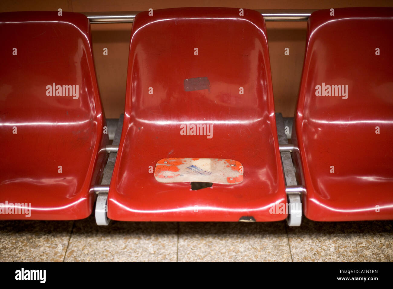 deteriorate seat in a row of red empty stadium plastic chairs Stock ...