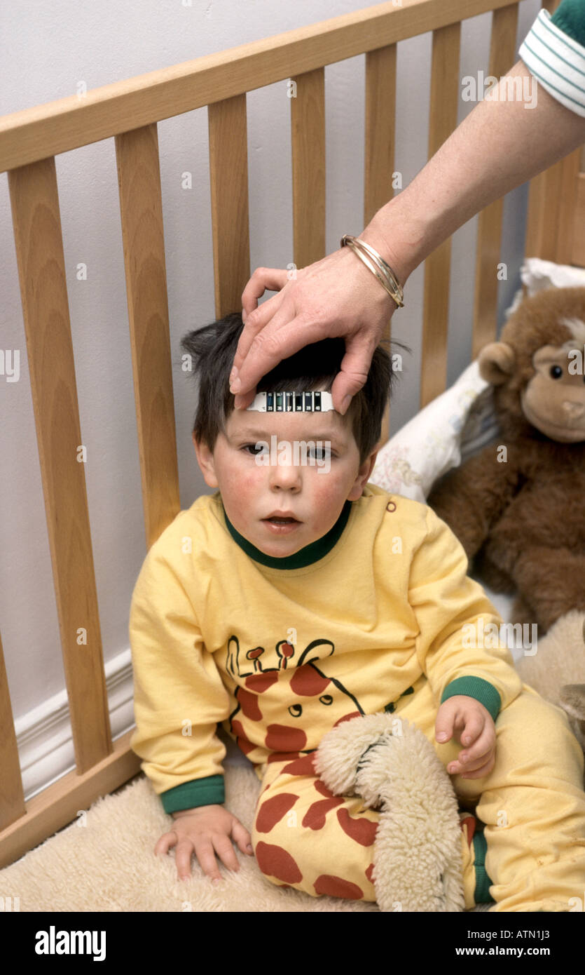 toddler having temperature taken with forehead thermometer strip Stock ...