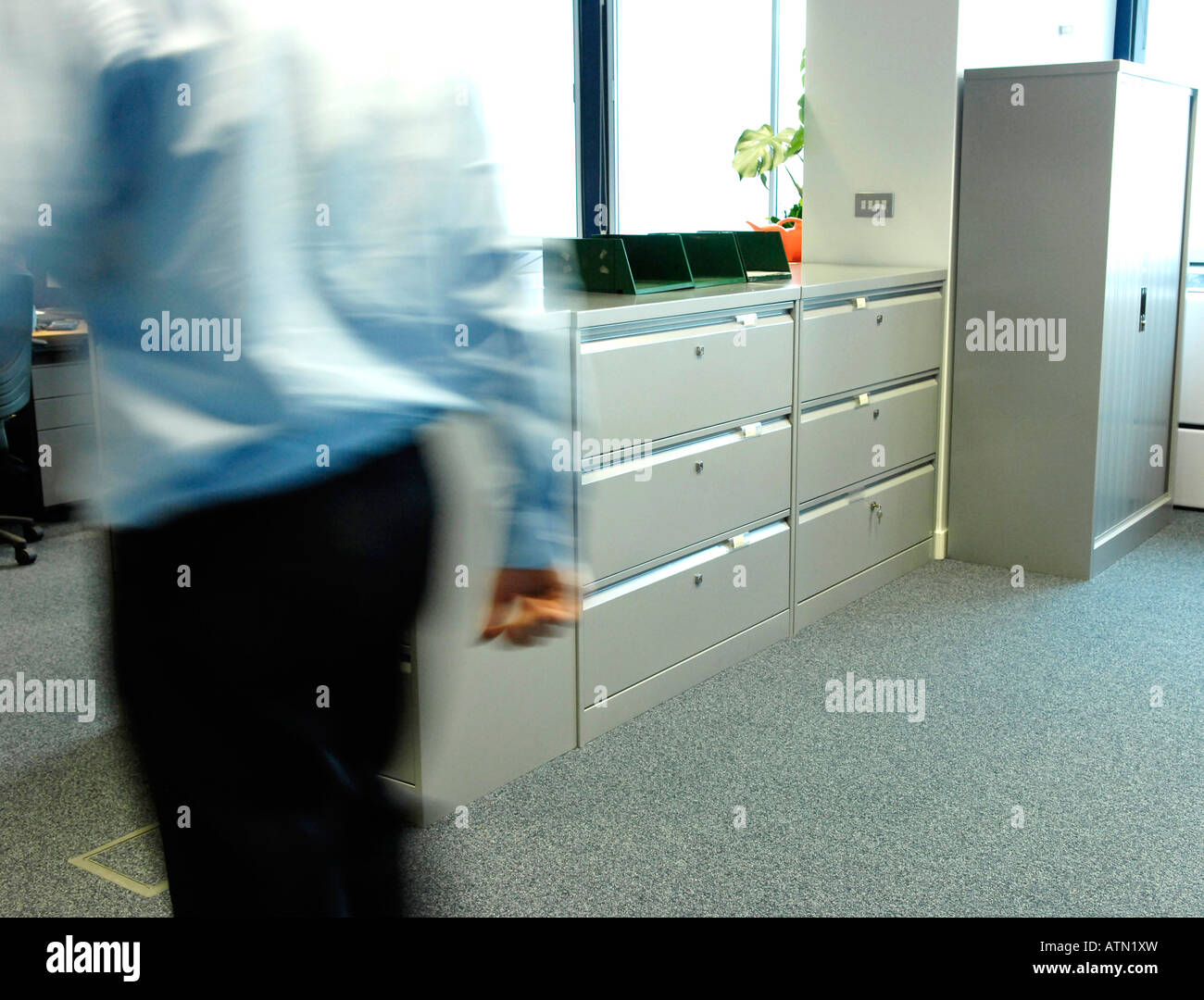 man walking in office Stock Photo - Alamy